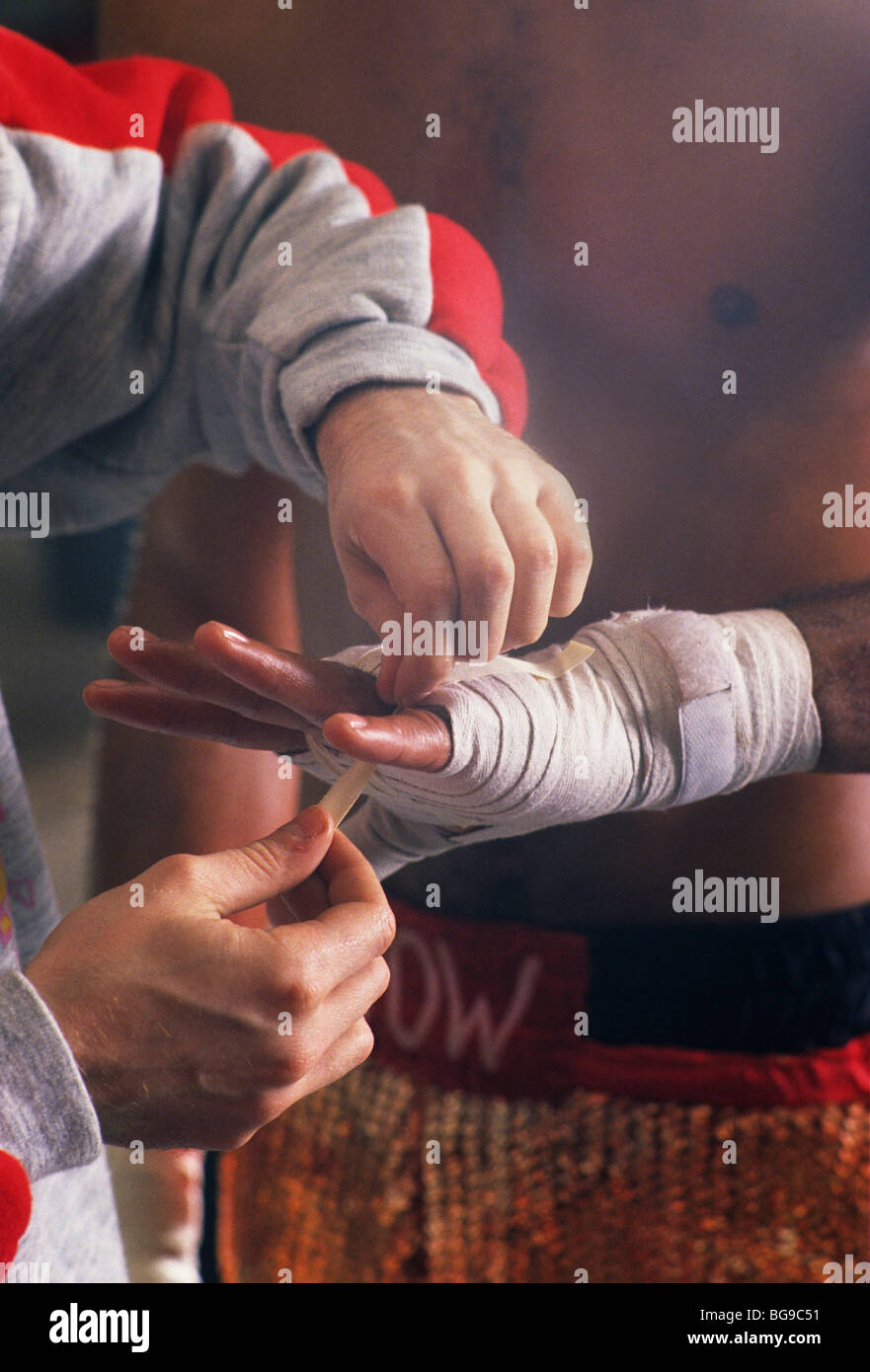 Trainer taping boxers hand Stock Photo - Alamy