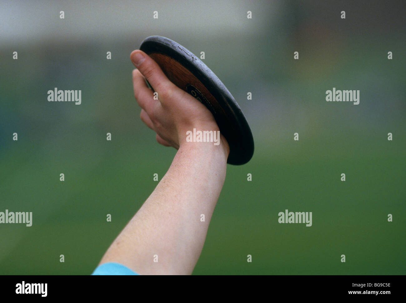 Discus in hand Stock Photo - Alamy