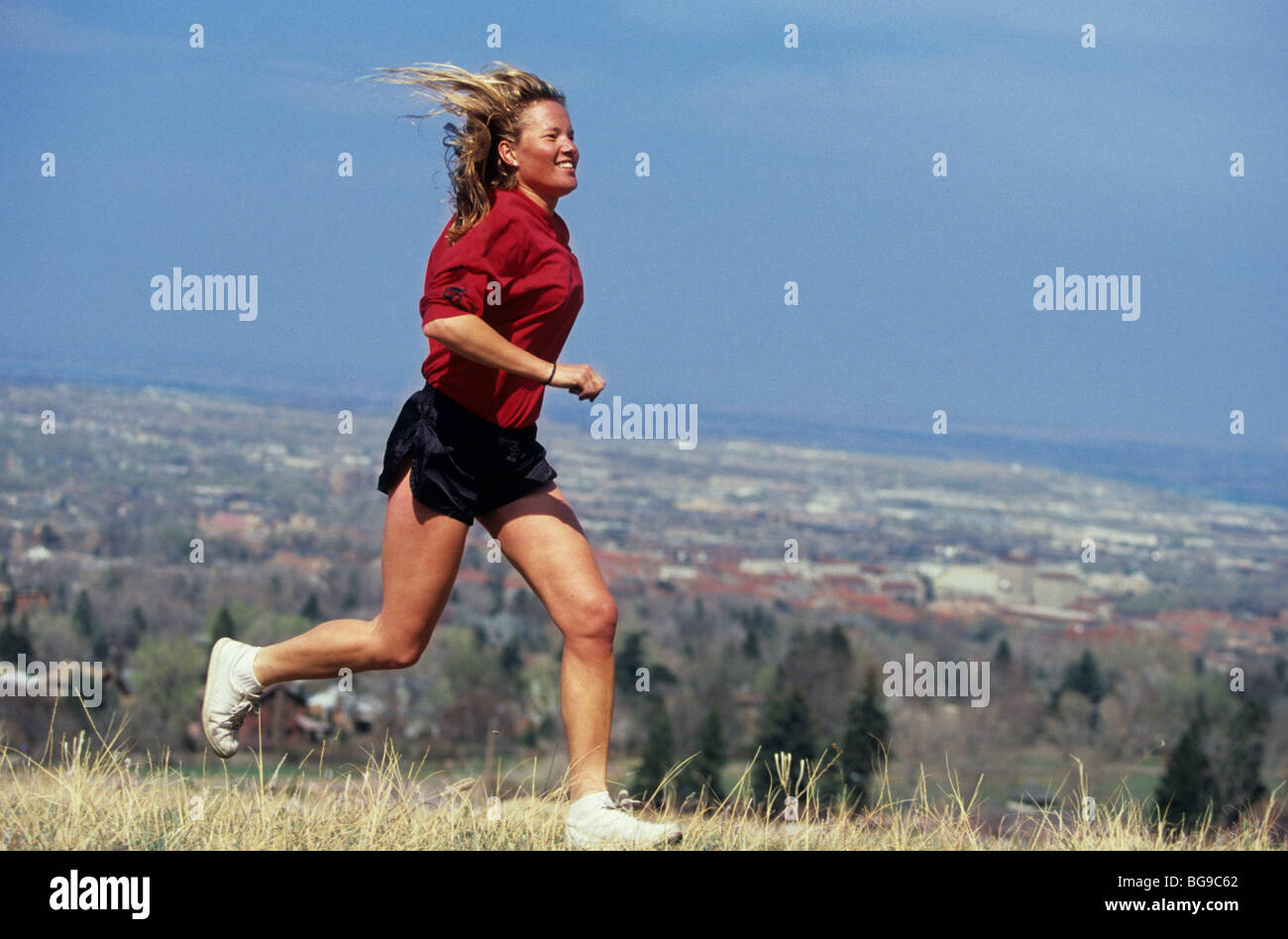 Woman running across grass hi-res stock photography and images - Alamy