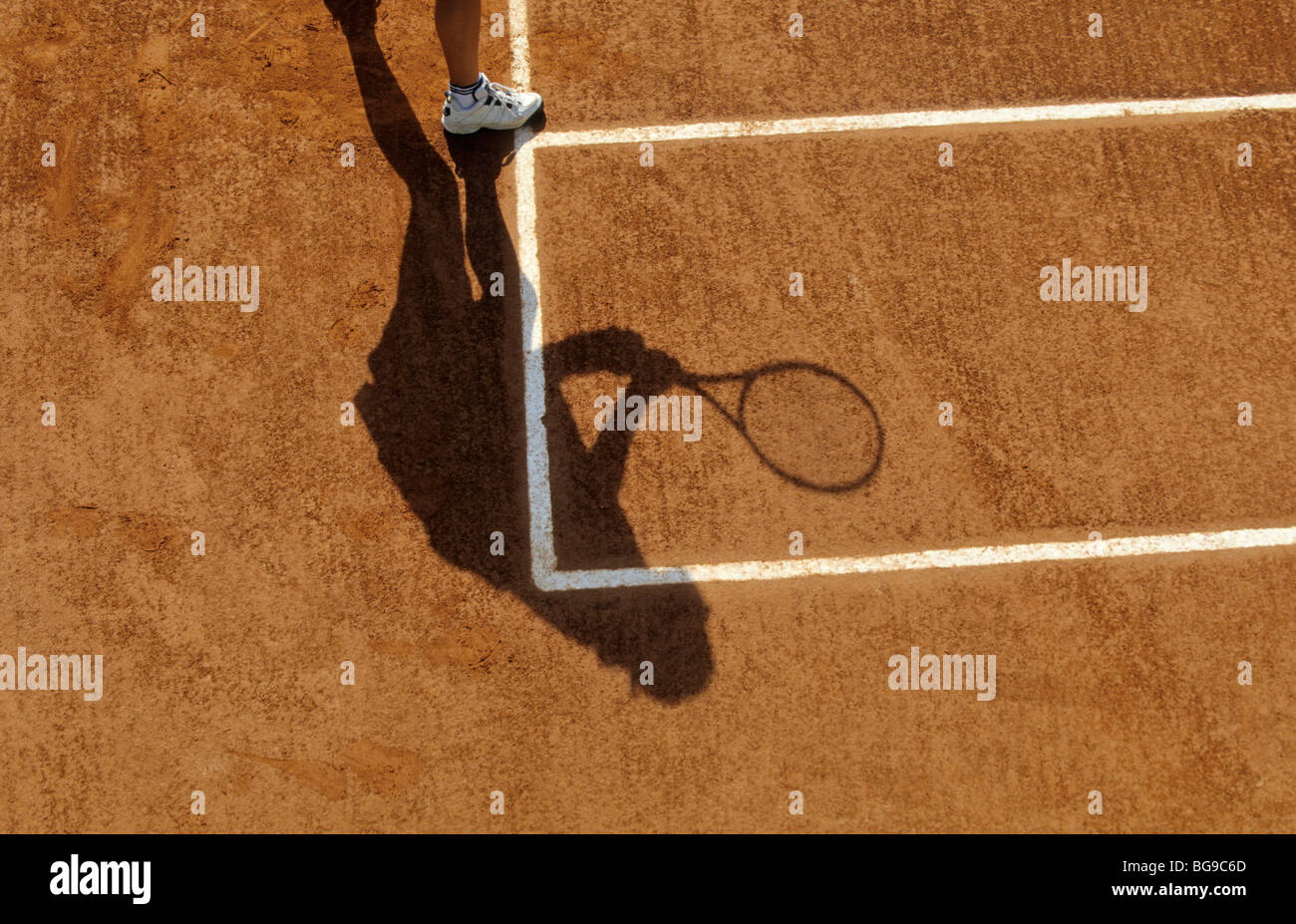Shadow of a tennis player on a clay court Stock Photo - Alamy