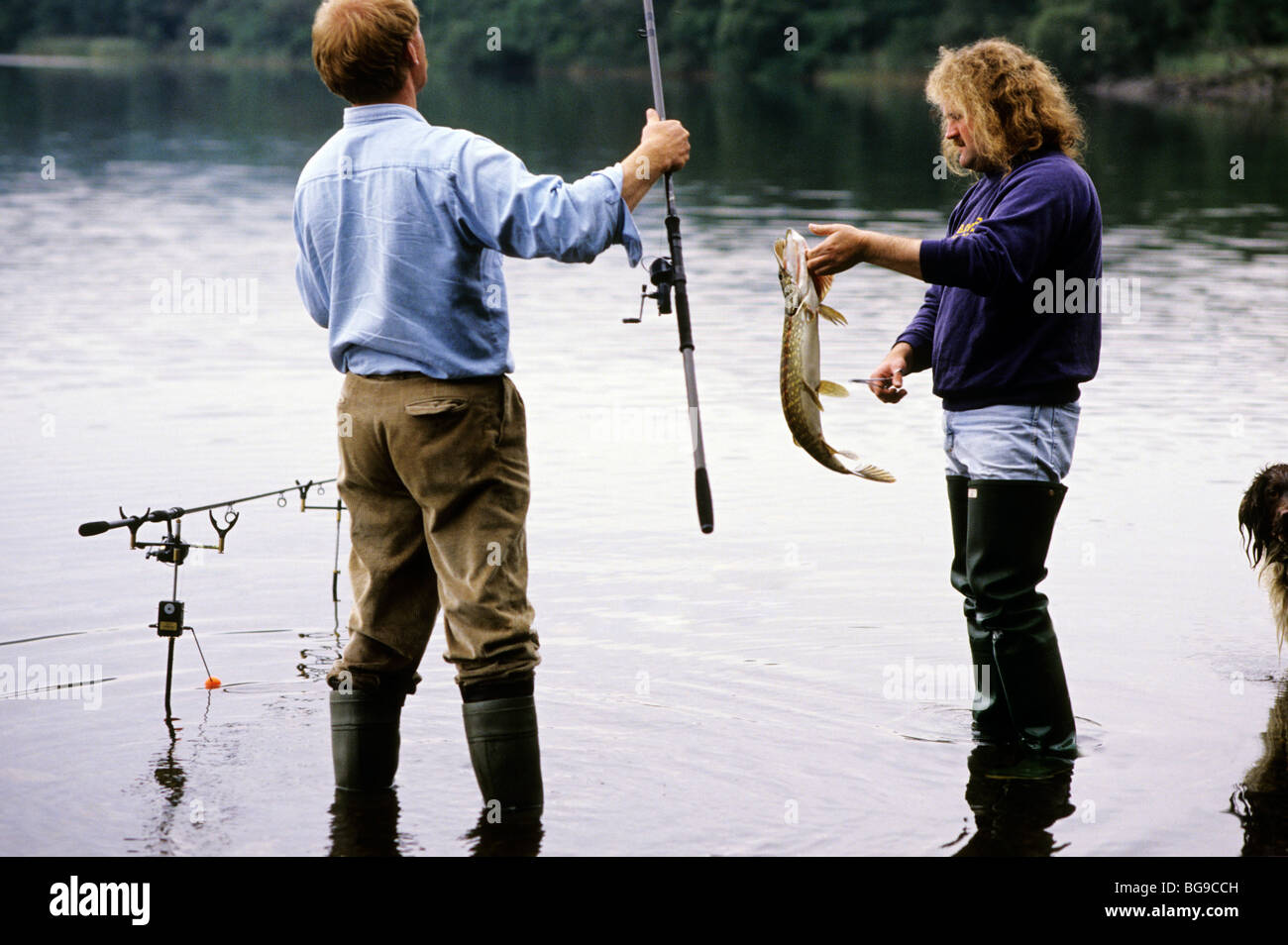 Two men fishing Stock Photo - Alamy