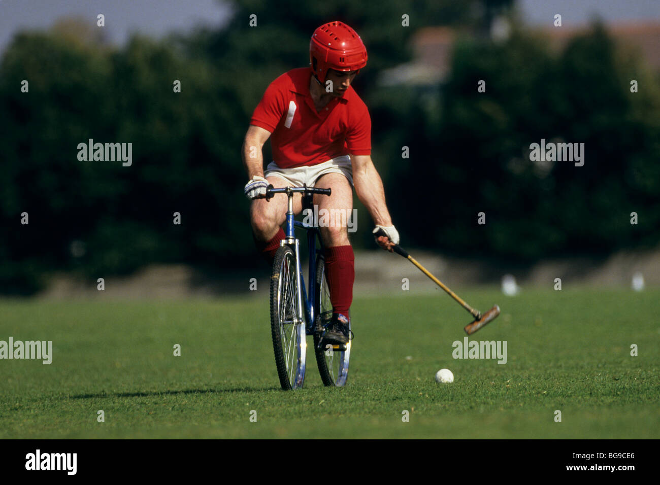 Young man playing bicycle polo Stock Photo - Alamy