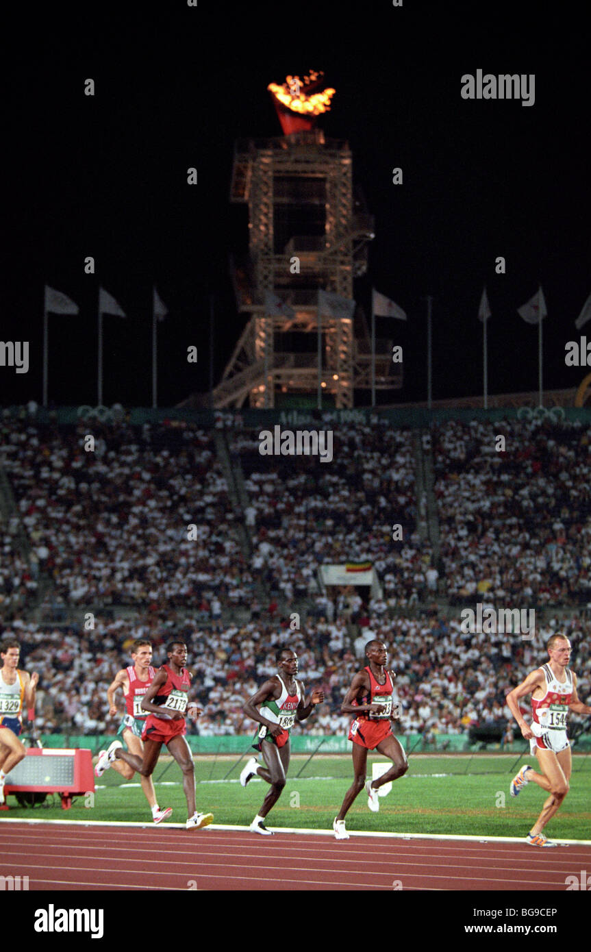 Olympic torch stands above an athletic field holding an event Stock ...