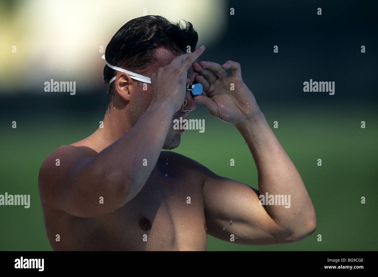 Swimmer putting on goggles Stock Photo - Alamy