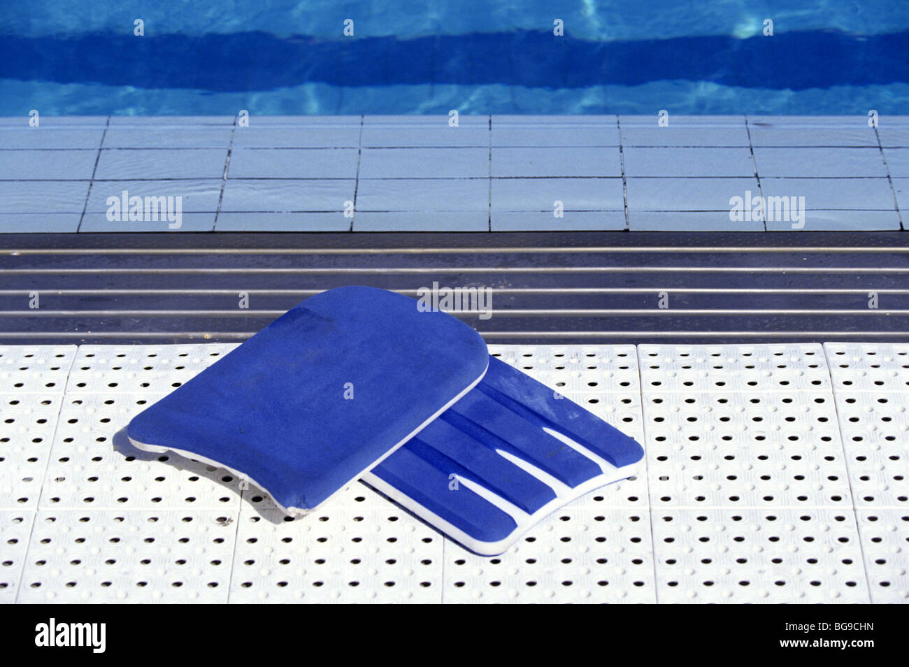 Two pool floats by the side of a pool Stock Photo - Alamy