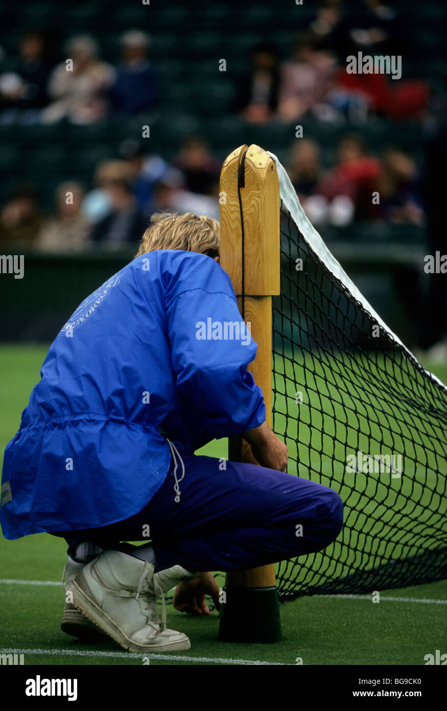 Official setting up a tennis court net Stock Photo - Alamy