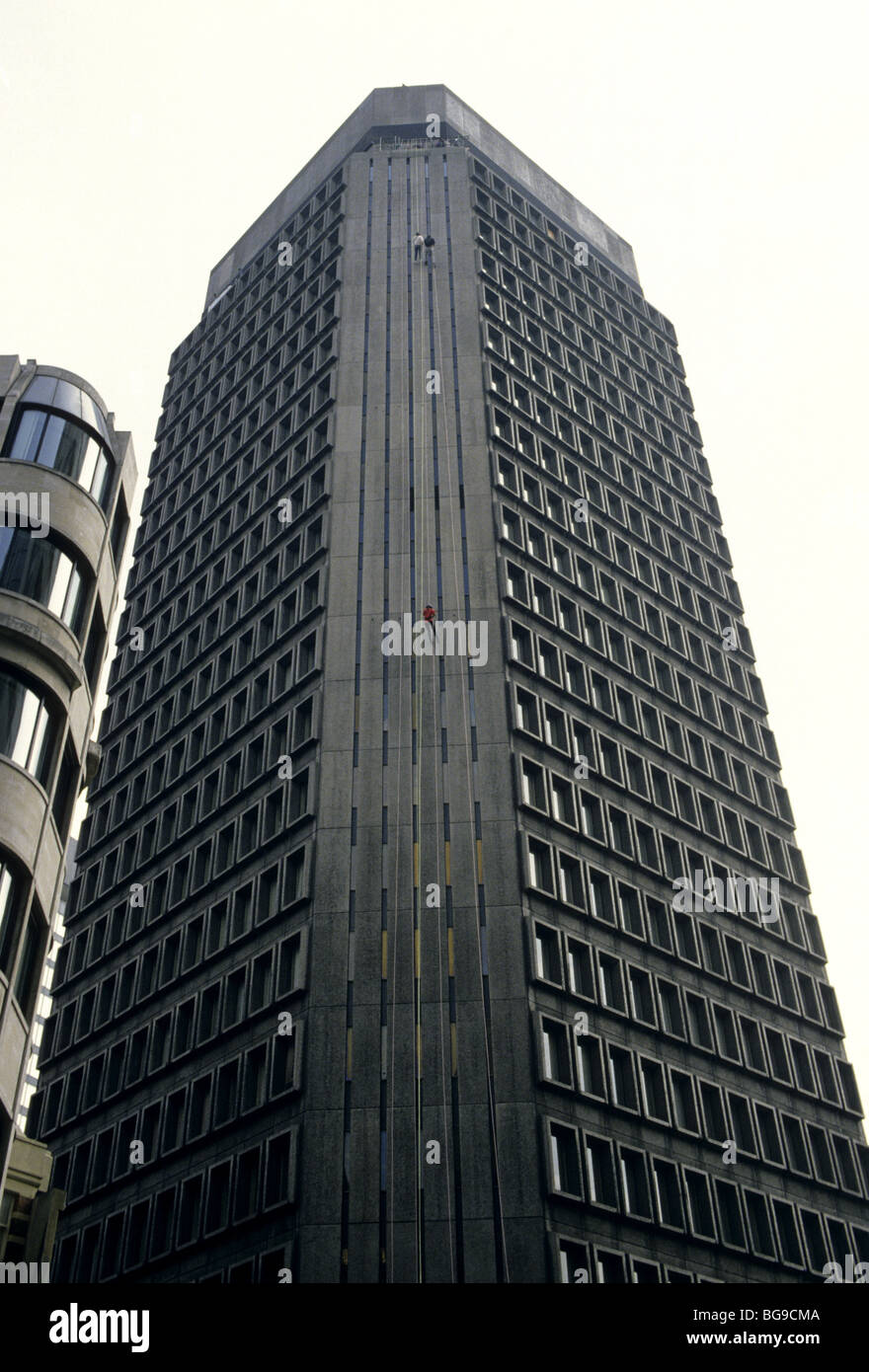Three men abseiling a high rise building Stock Photo - Alamy