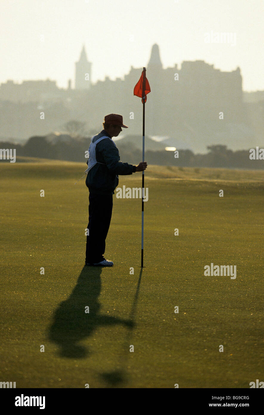 Golf caddy holding flag hi-res stock photography and images - Alamy