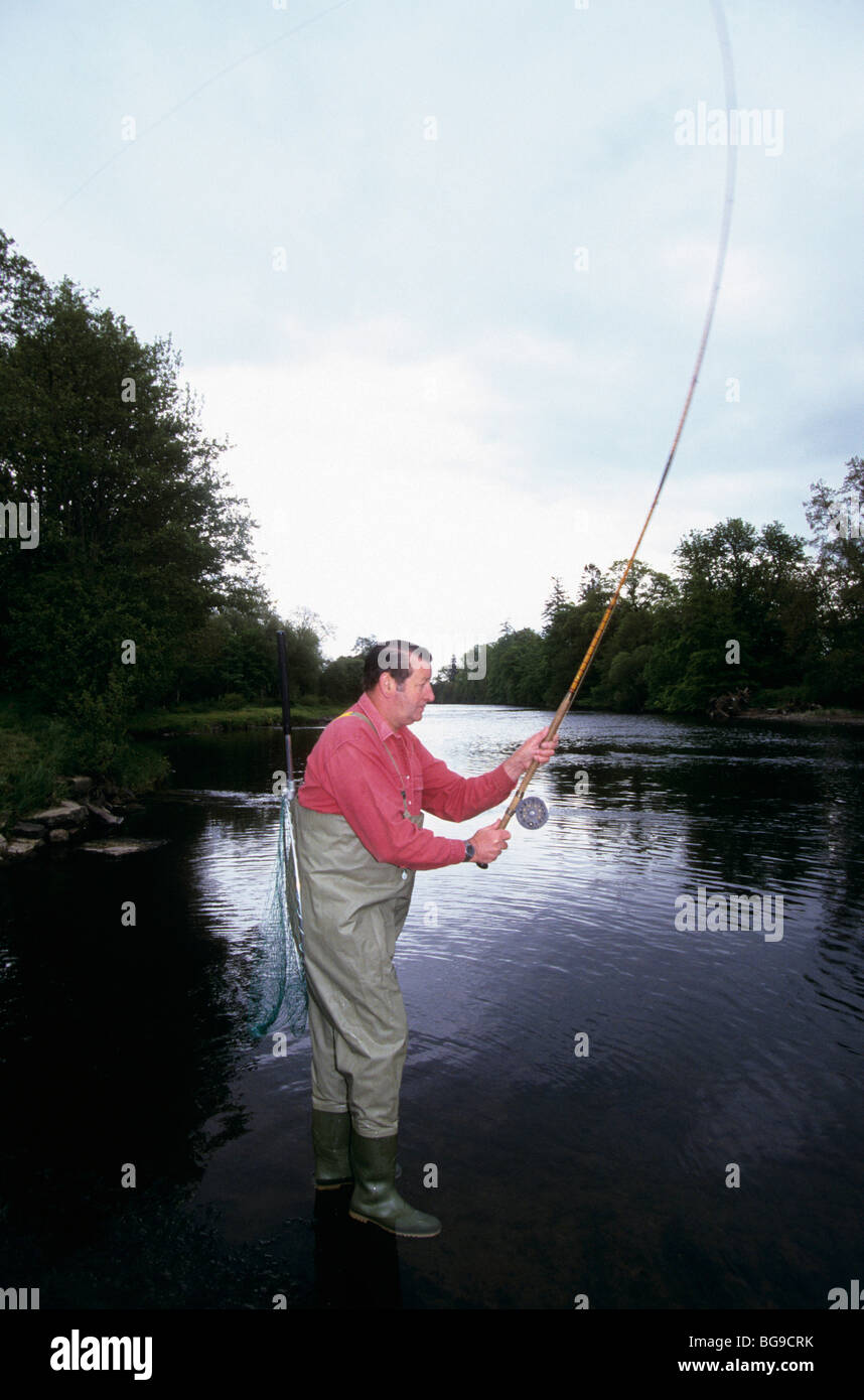 Man casting his fishing rod Stock Photo - Alamy