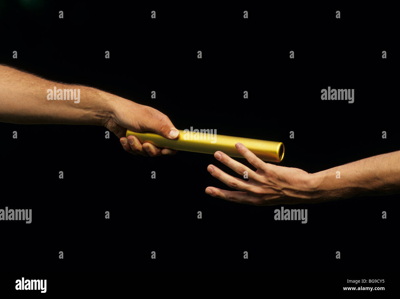 Two athletes passing a baton Stock Photo - Alamy