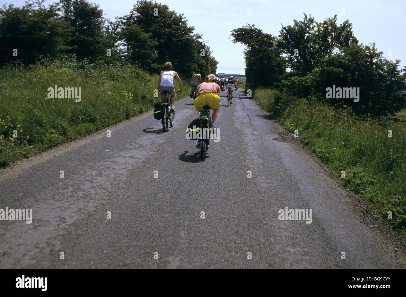 Rear view of a group of cyclists on a rural road Stock Photo - Alamy
