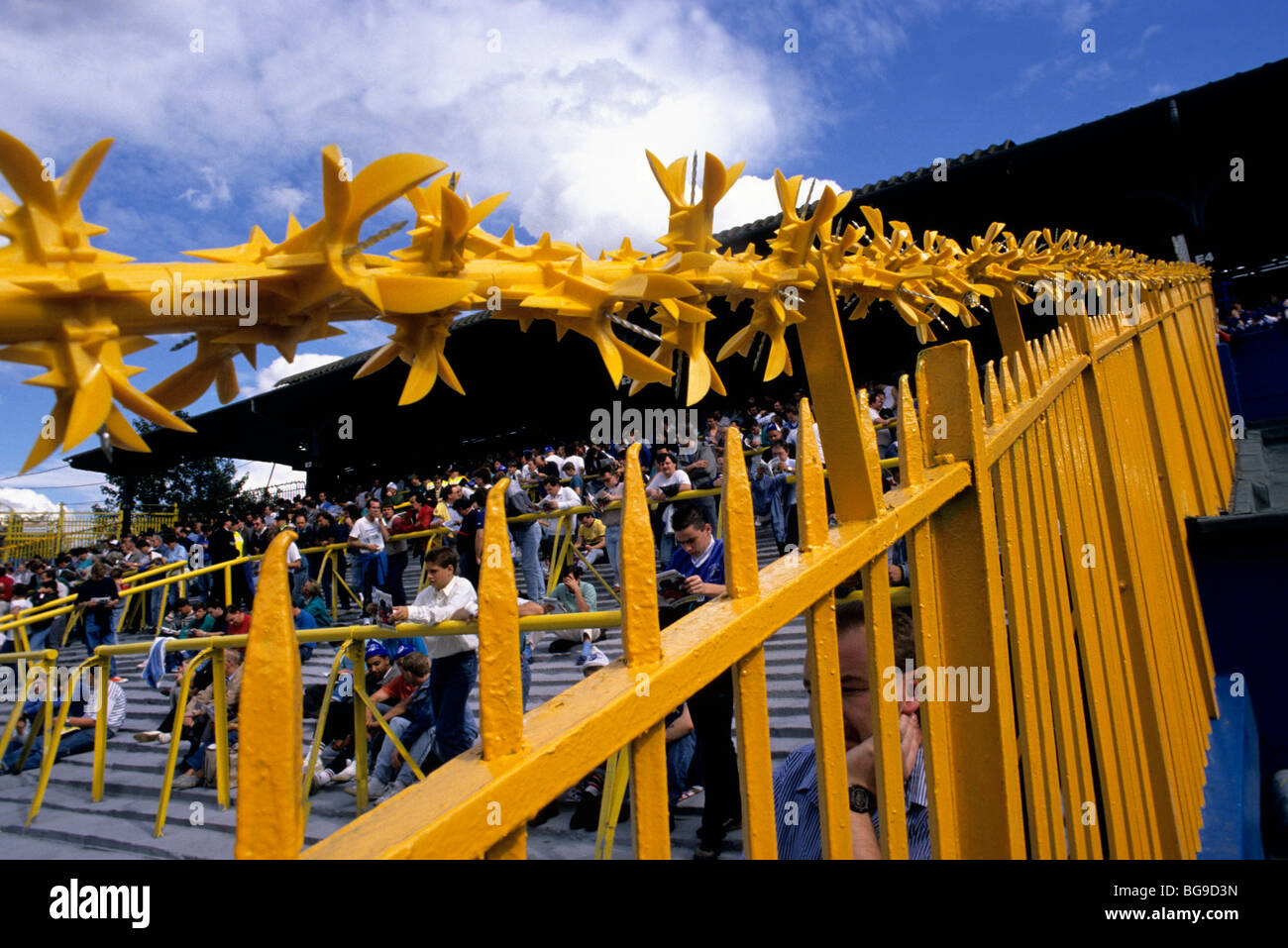 Security fence seperating fans at a football ground Stock Photo - Alamy
