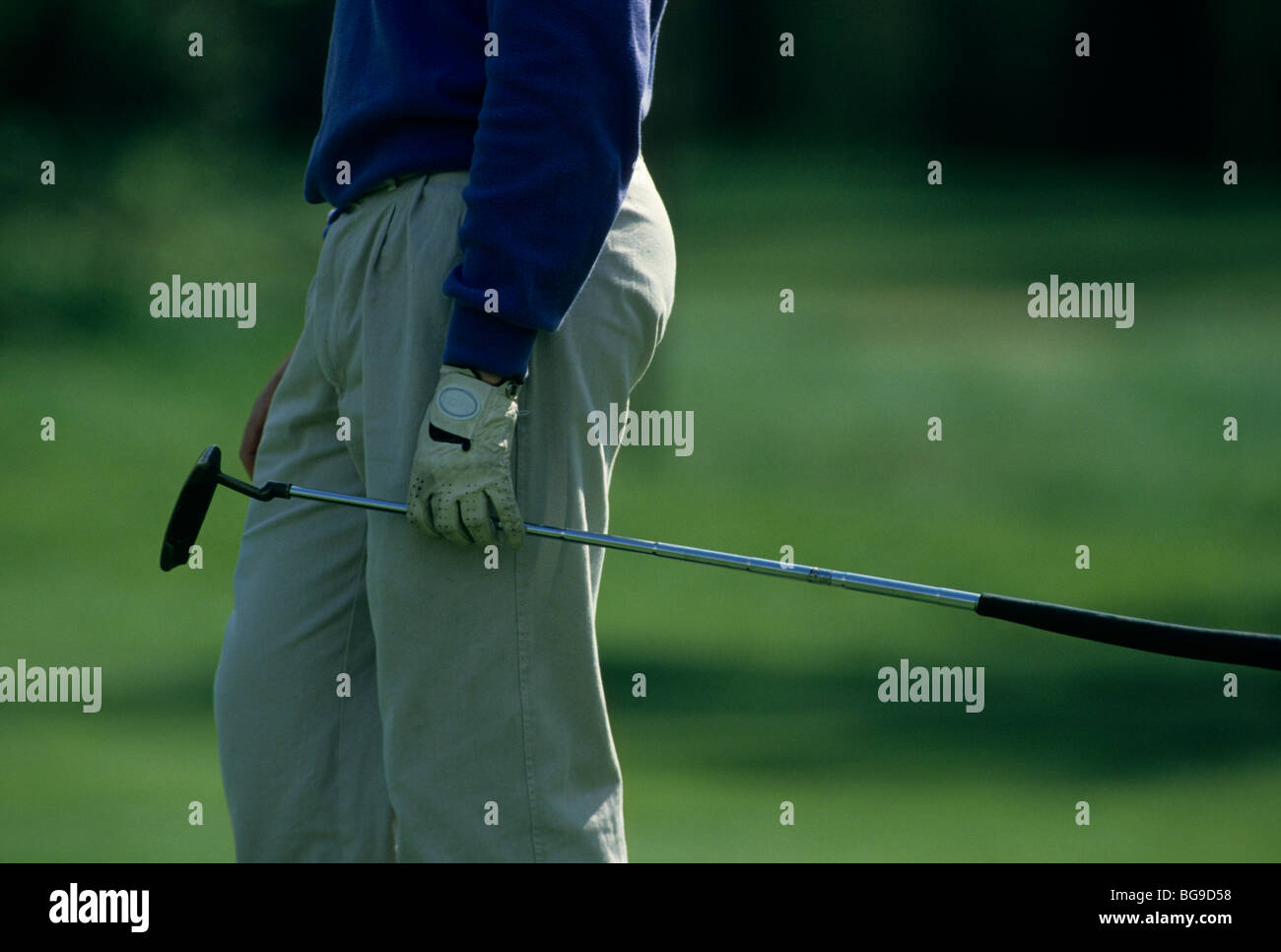 Golfer holding his golf club Stock Photo - Alamy