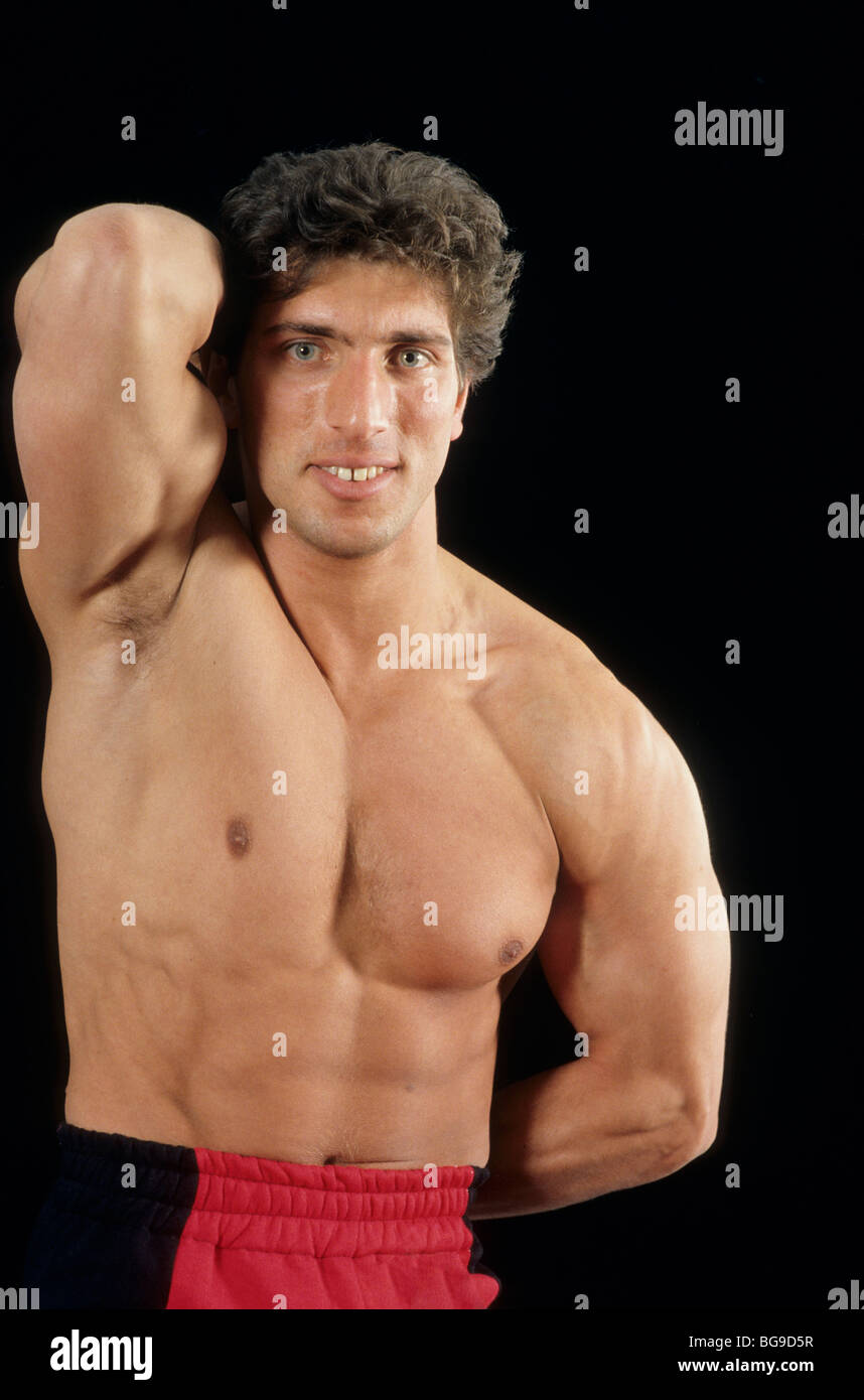 Man displaying muscle tone of upper body Stock Photo - Alamy