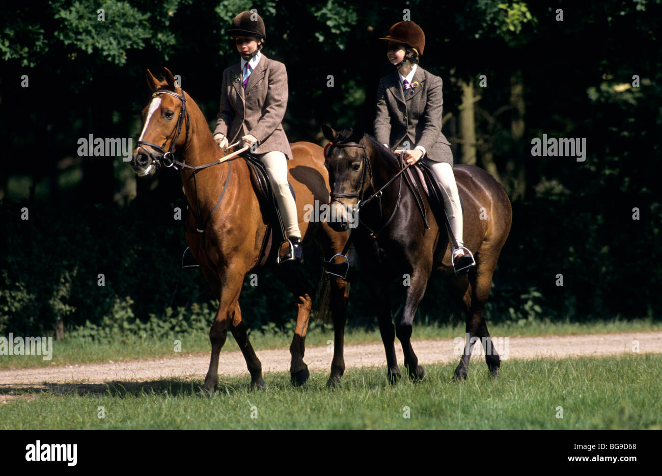 Two young horse riders on their horses Stock Photo - Alamy