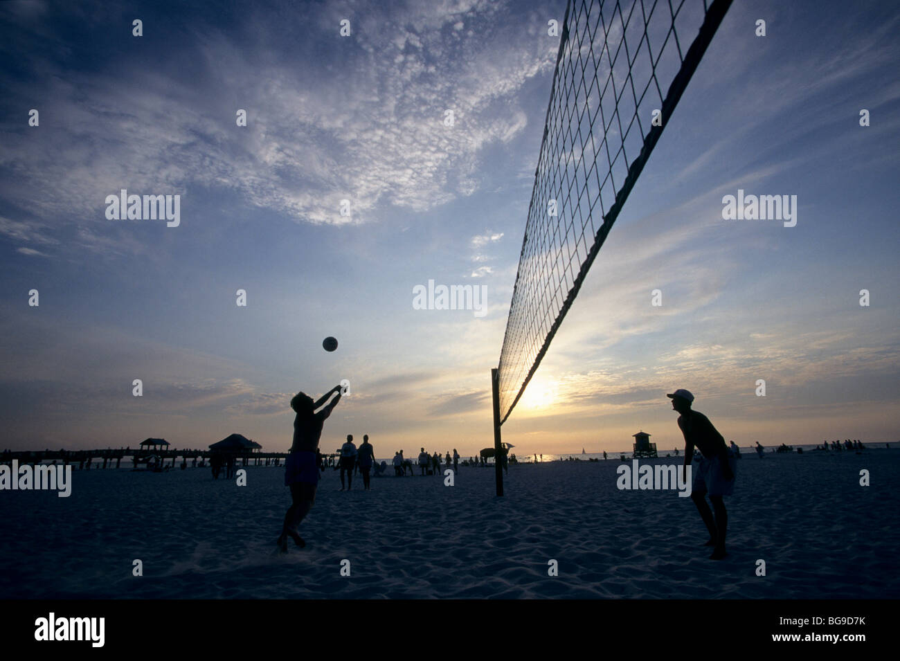 Beach volleyball match at sunset Stock Photo - Alamy