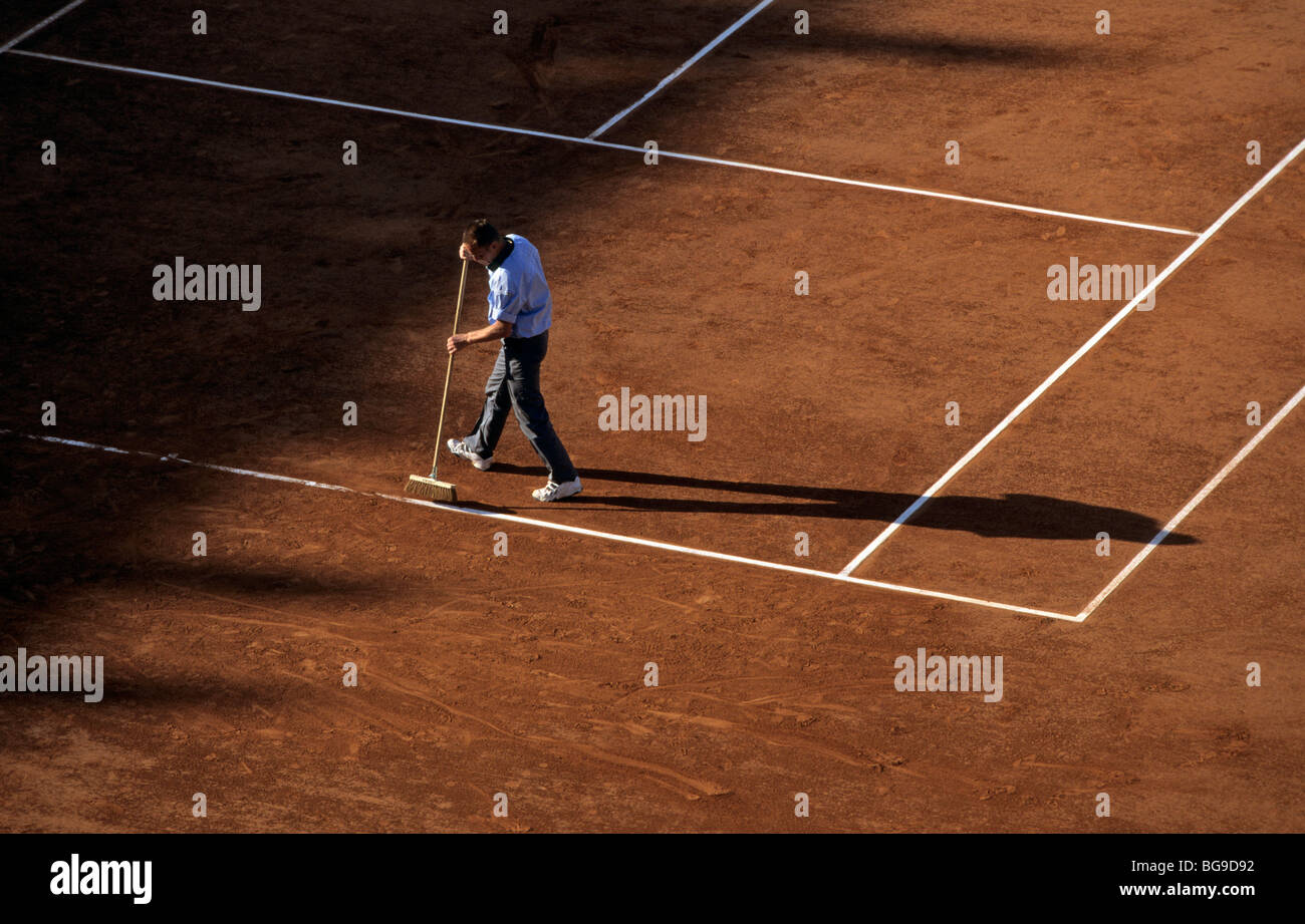 Groundskeeper cleaning the service lines on a clay court Stock Photo ...