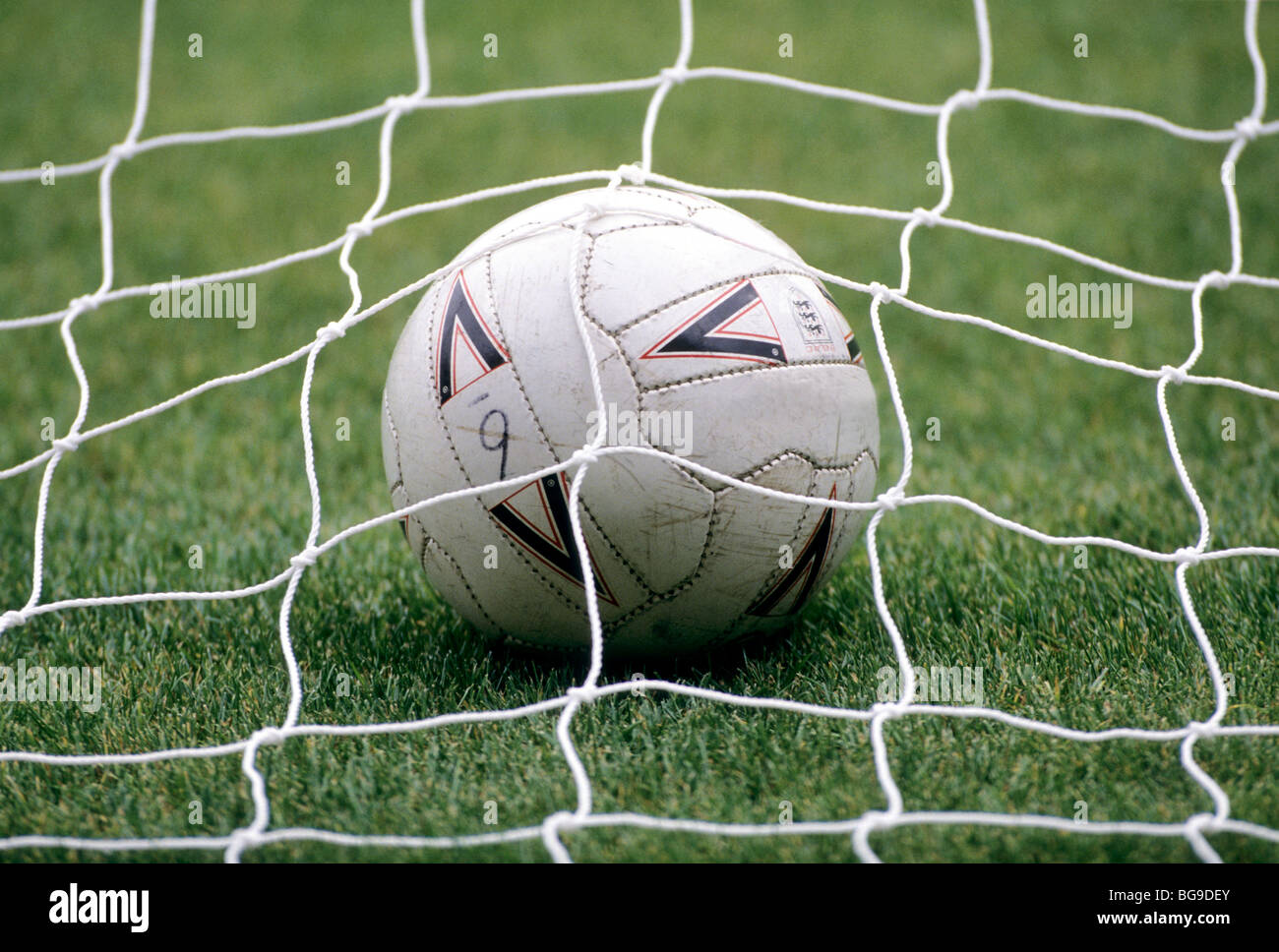 Football in the back of the net Stock Photo - Alamy