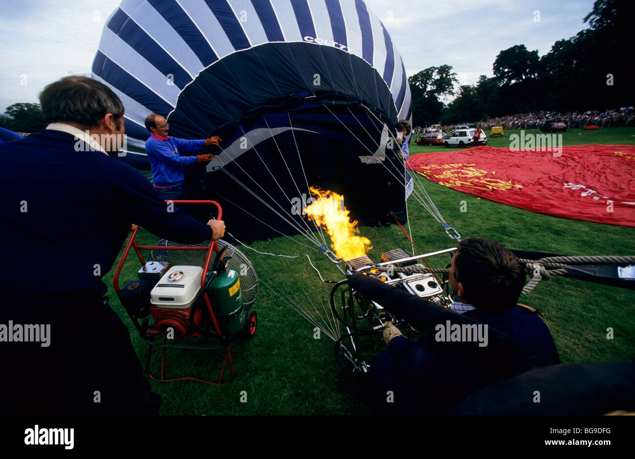 Crew members using a burner to inflate a hot air balloon Stock Photo ...
