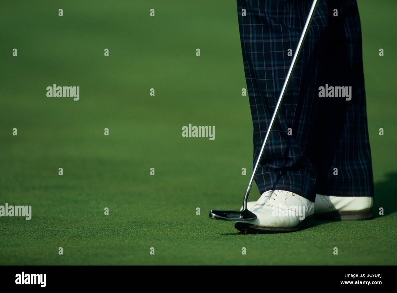 Golfer with a putter Stock Photo - Alamy