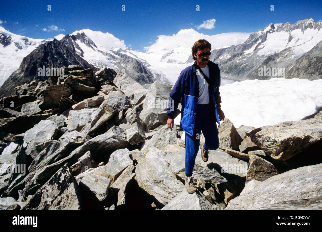 Hill walker walking along a the crest of a snow topped mountain Stock ...