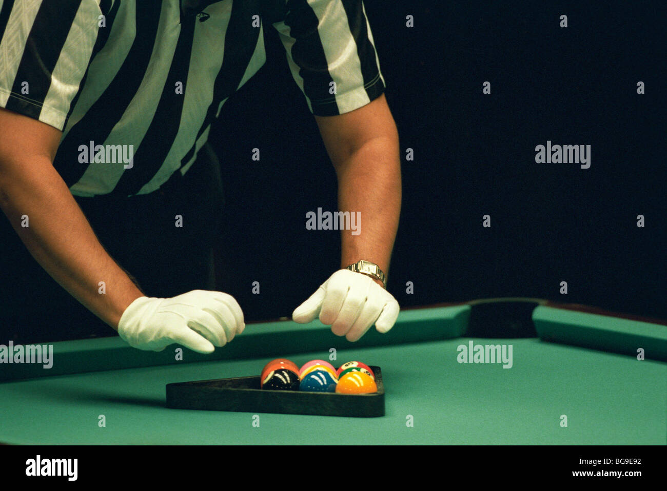Referee sets up the rack of pool balls Stock Photo - Alamy