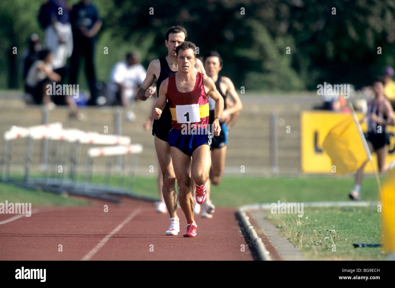 Group of male runners racing on a track Stock Photo - Alamy