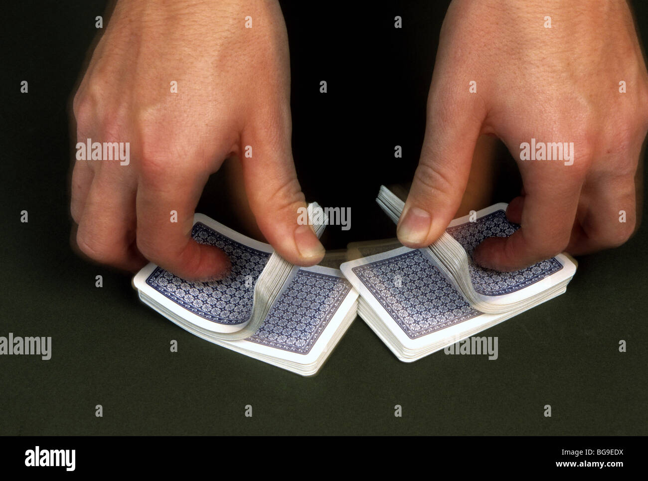Man shuffling a deck of cards Stock Photo - Alamy