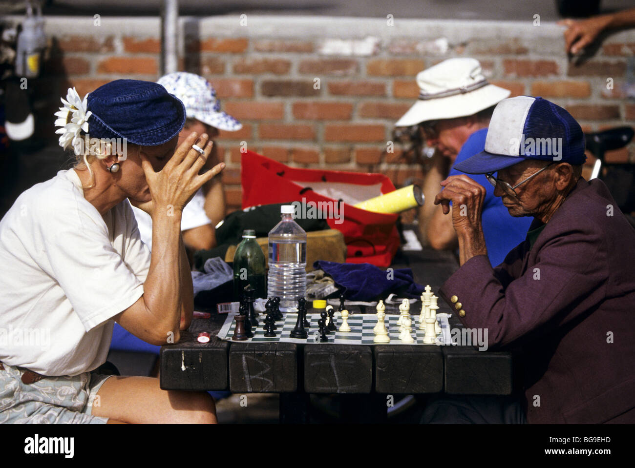 Four people playing chess Stock Photo - Alamy