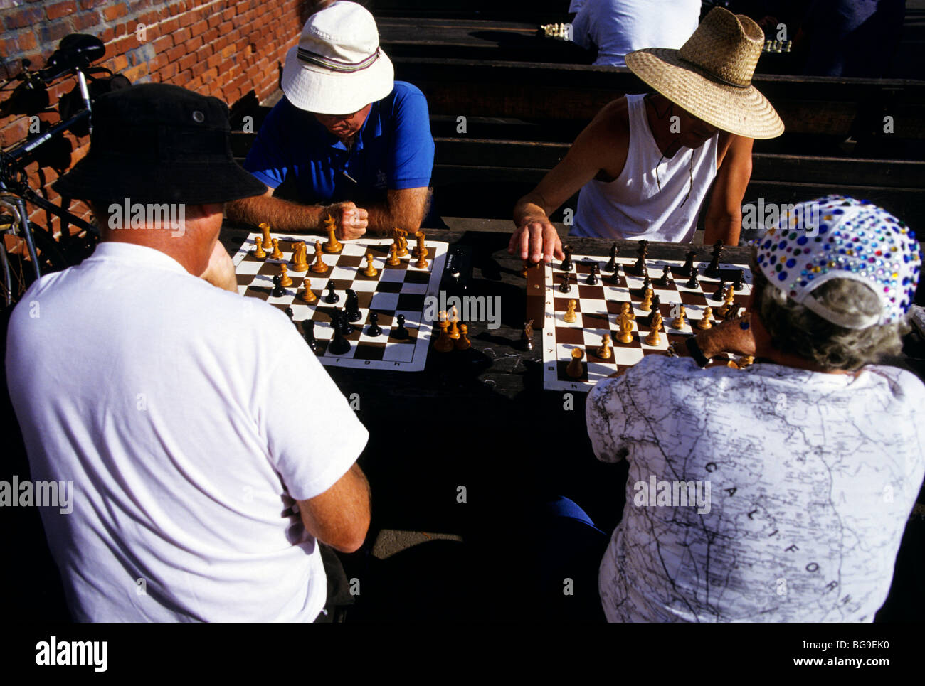 Four people playing chess Stock Photo - Alamy