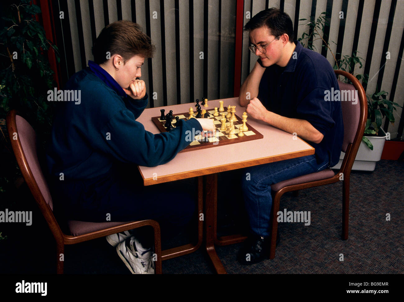 Man and woman playing chess Stock Photo - Alamy