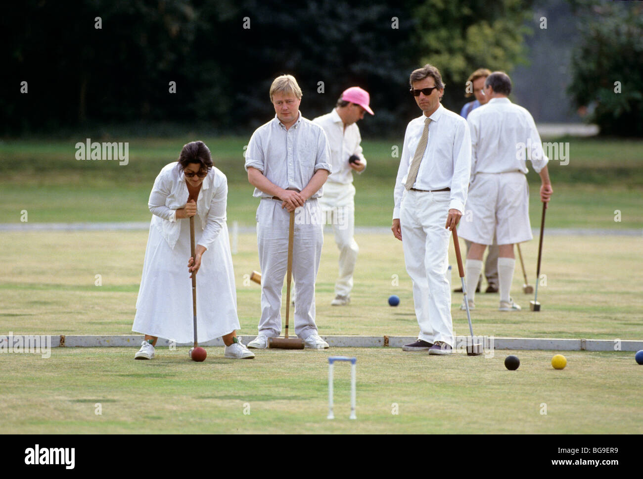 Two groups of players playing croquet Stock Photo - Alamy