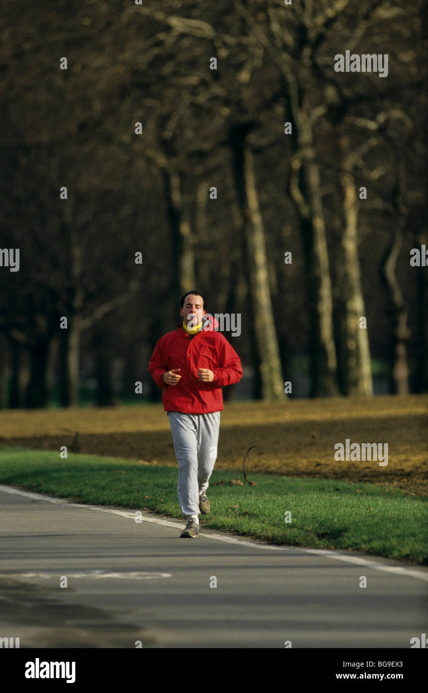 Man jogging through a park Stock Photo - Alamy