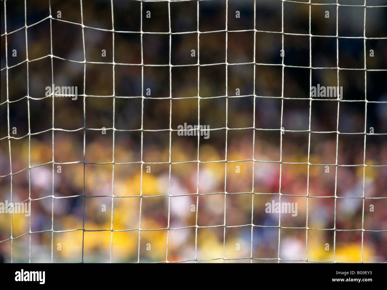 Goal net with football fans in background Stock Photo - Alamy