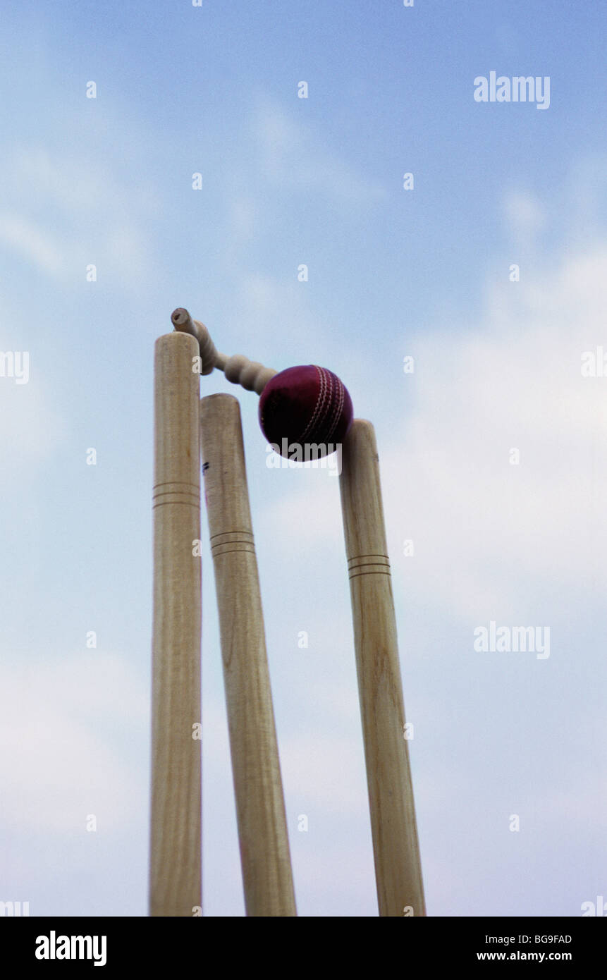 Close up of red cricket ball striking the stumps Stock Photo - Alamy