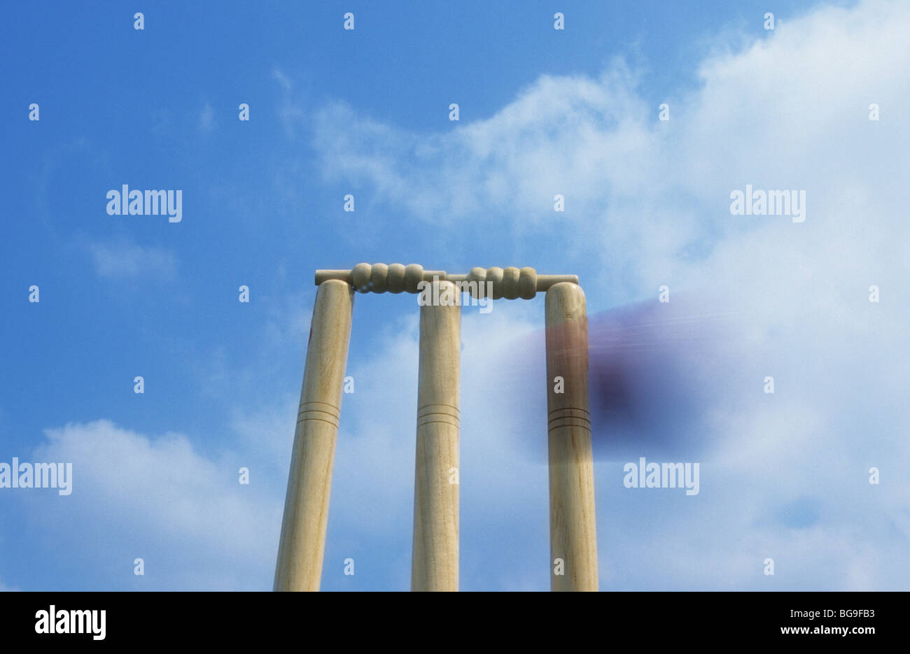Close up of red cricket ball about to strike the stumps Stock Photo - Alamy