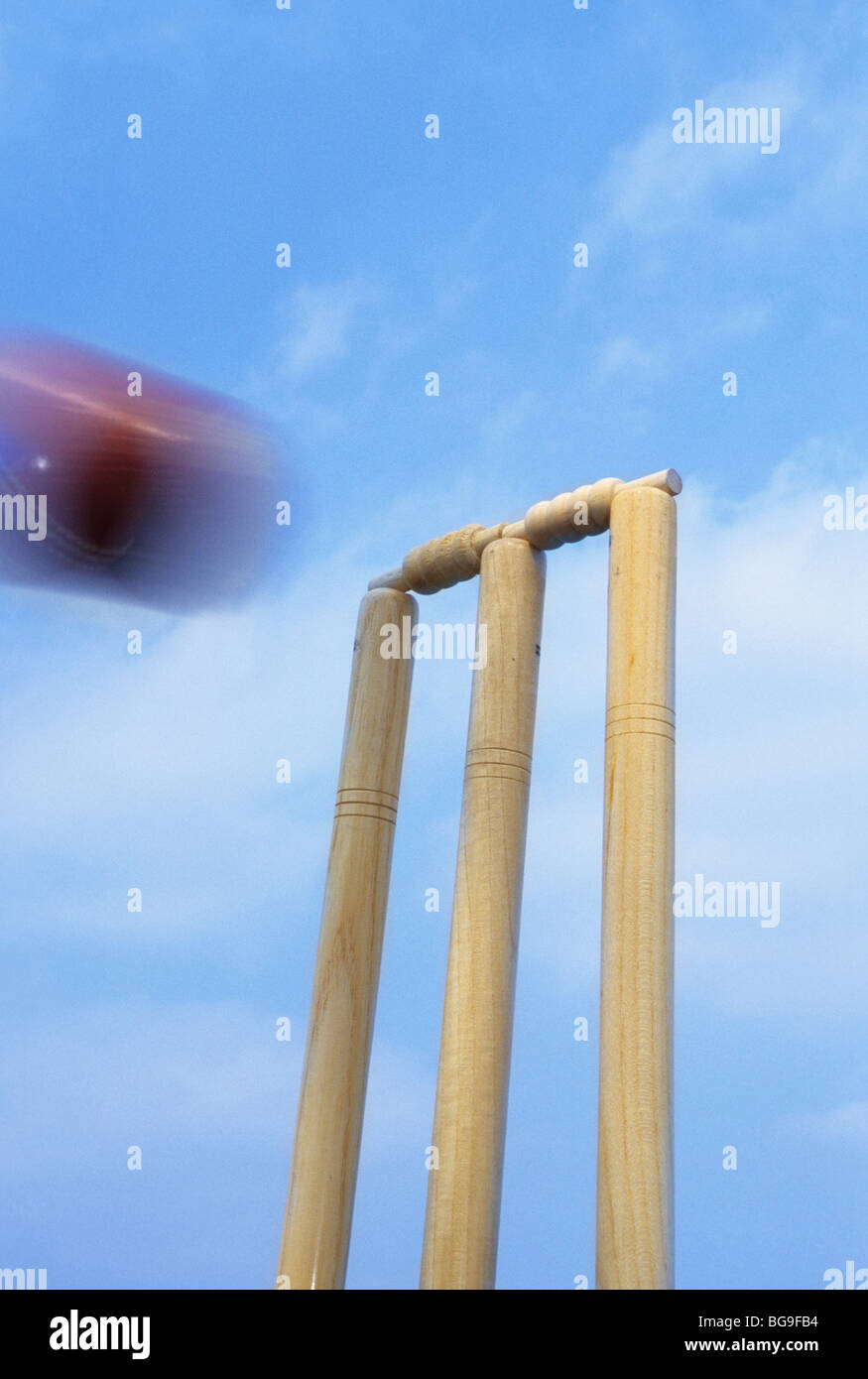Close up of red cricket ball about to strike the stumps Stock Photo - Alamy