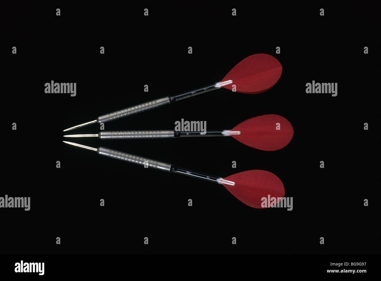 Three darts with red flights Stock Photo - Alamy