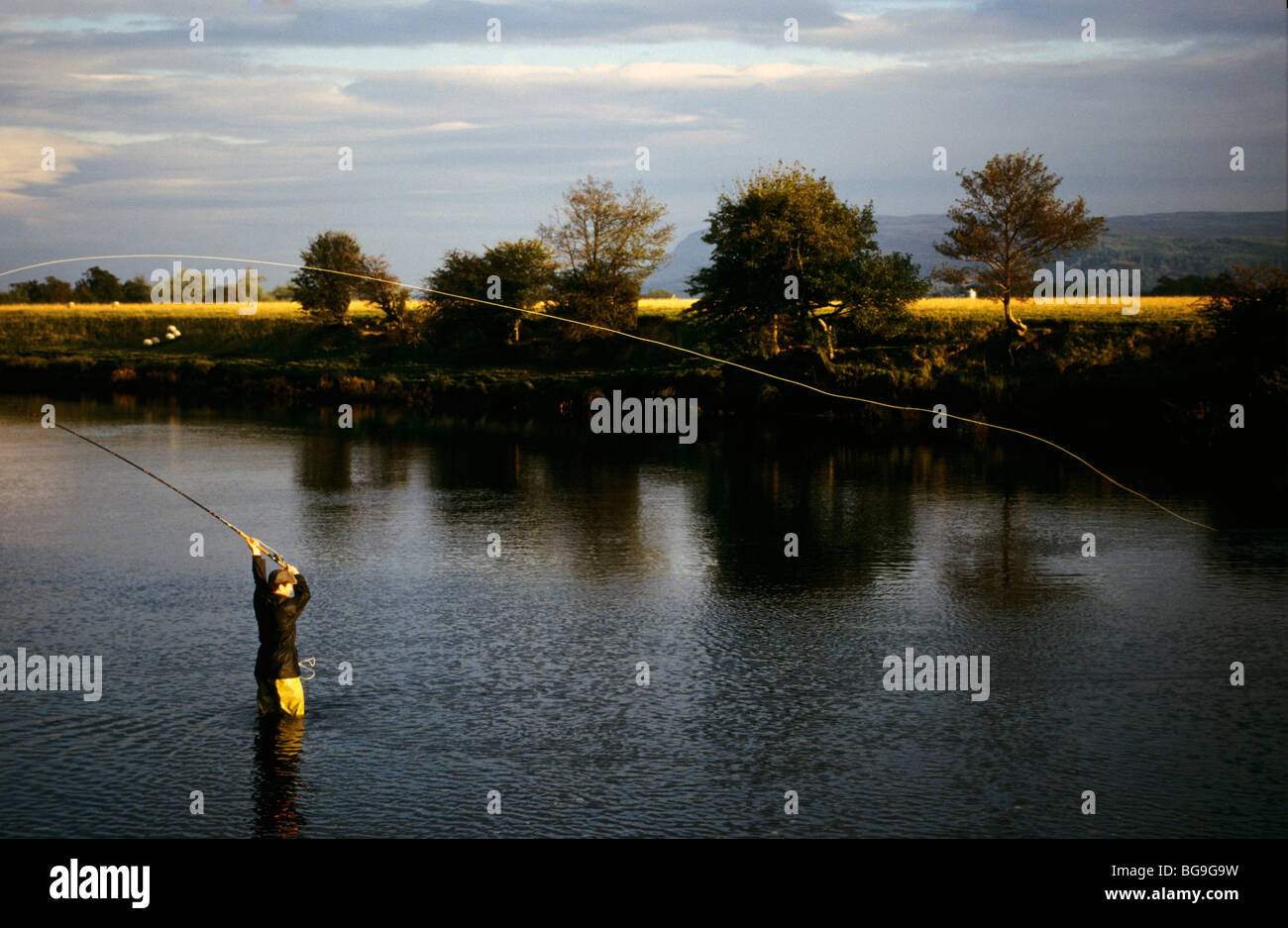 Man casting his fishing rod Stock Photo - Alamy