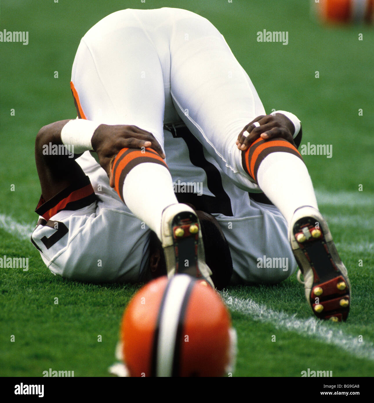 American football player stretches out his back before a game Stock ...