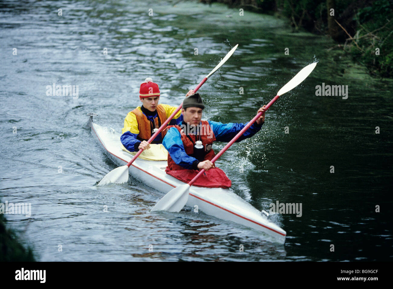 Two men Kayaking on a river Stock Photo - Alamy