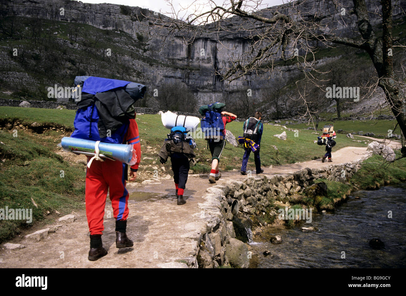 Group of walkers walking along a stream side path Stock Photo - Alamy