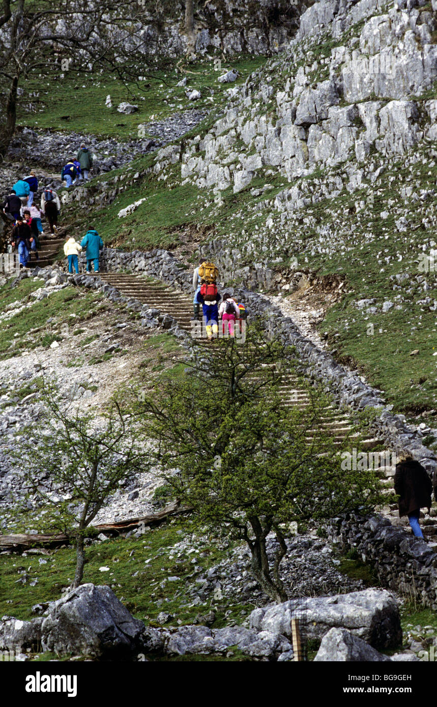 Group of walkers walking along a rocky step path Stock Photo - Alamy