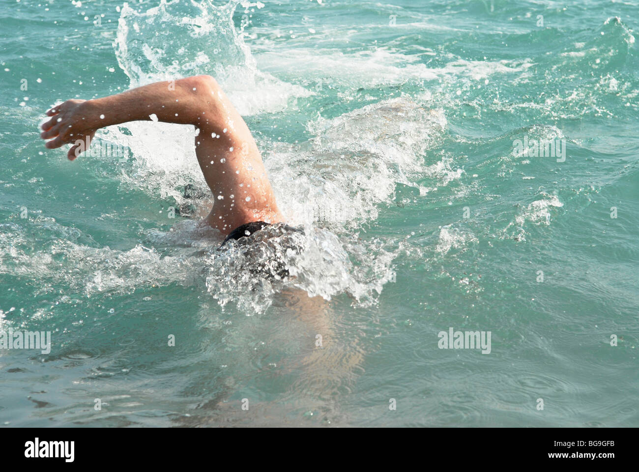 Male swimmer swimming front crawl in the sea Stock Photo - Alamy