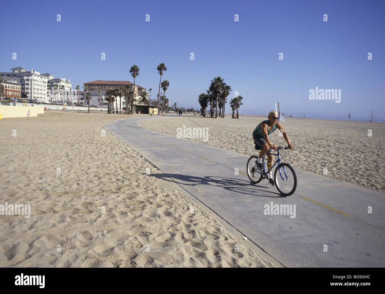 Man cycling on a beach bike path Stock Photo - Alamy