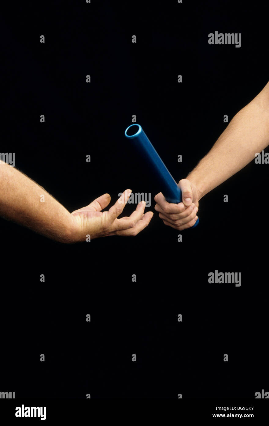 Two athletes passing a baton Stock Photo - Alamy
