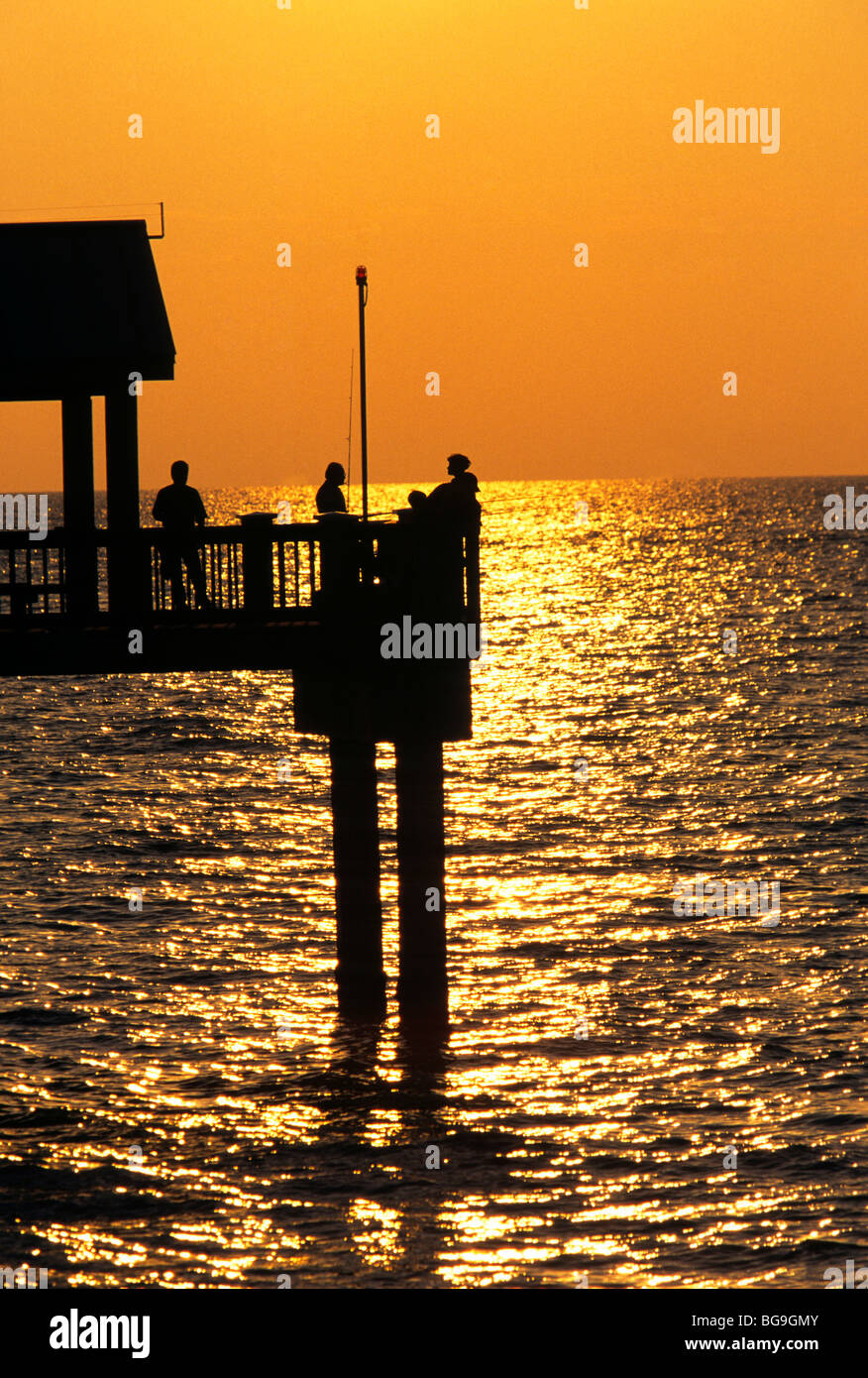 Silhouette of a group pier fishing Stock Photo - Alamy