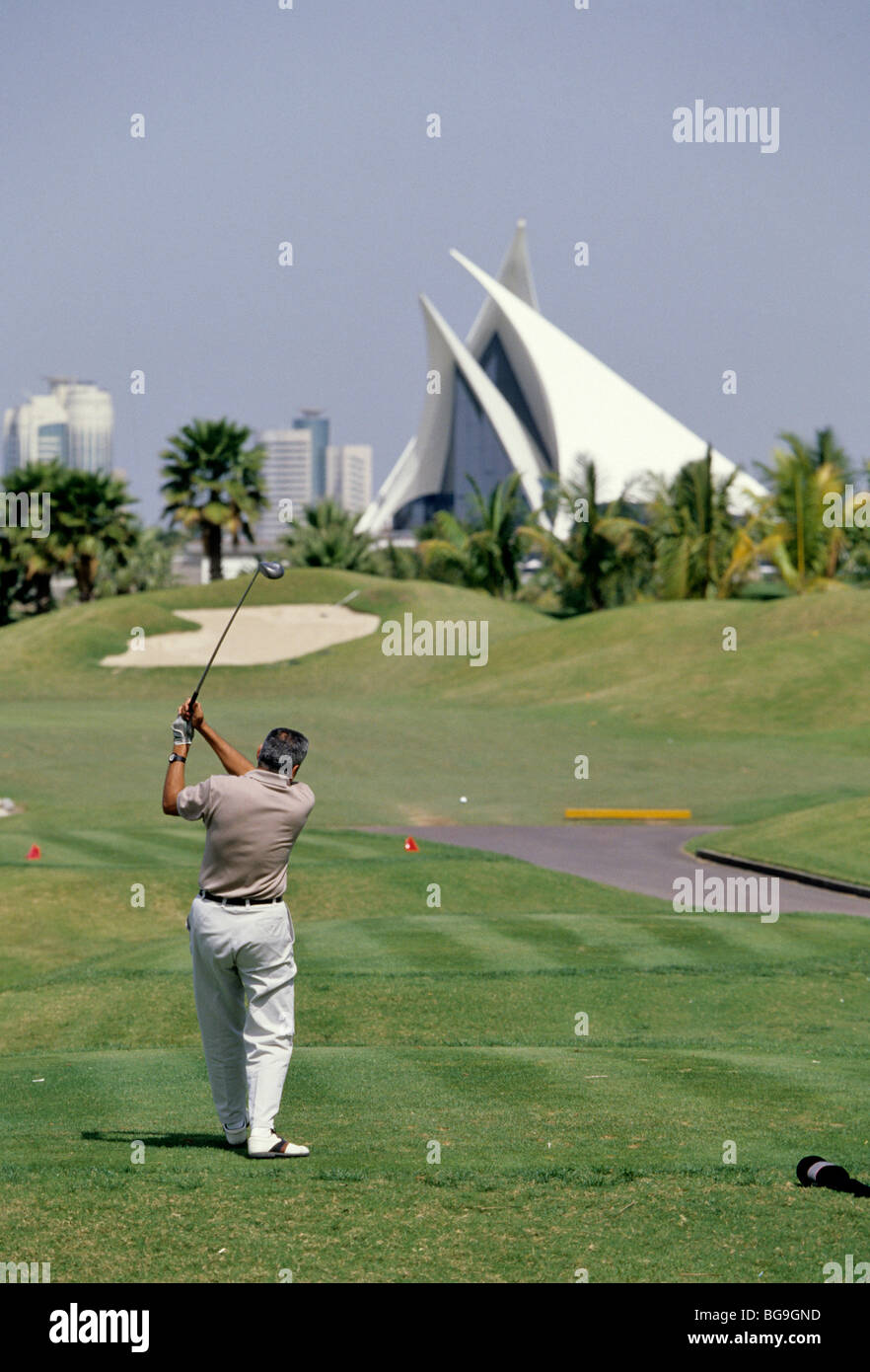 Golfer tees off on a golf course Stock Photo - Alamy