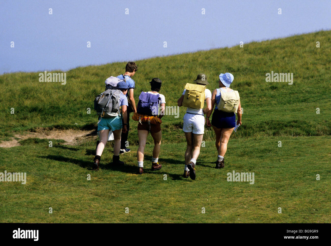 Group walking up a hill side Stock Photo - Alamy