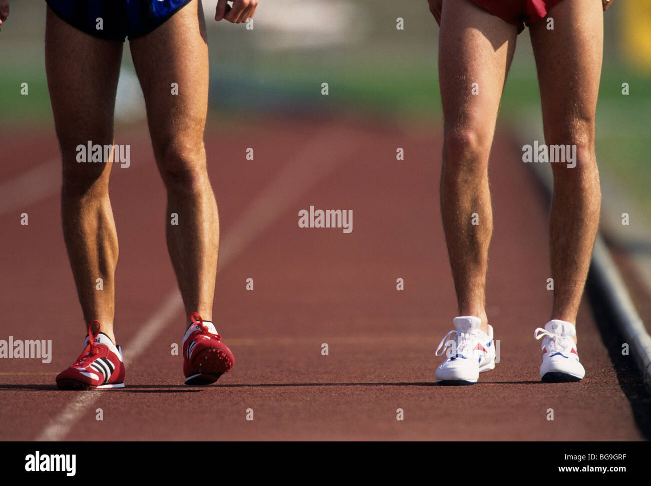 Two athletes walking on a track Stock Photo - Alamy